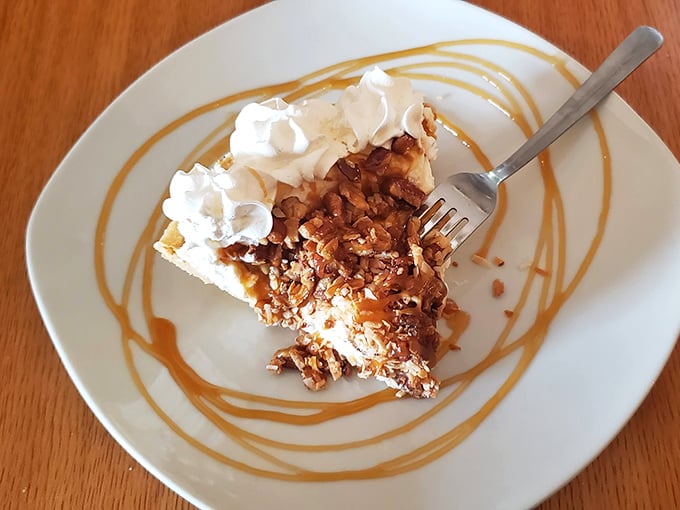 Caramel pecan pie with artistic sauce swirls &ndash; proof that dessert can be both a treat and a work of abstract expressionism.