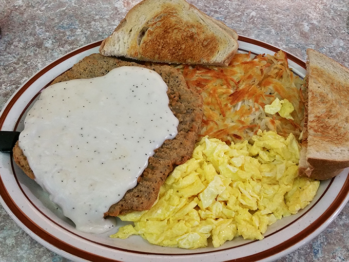 Country fried steak smothered in gravy that could make a vegetarian temporarily reconsider their life choices. The eggs and hash browns are just along for the glorious ride.