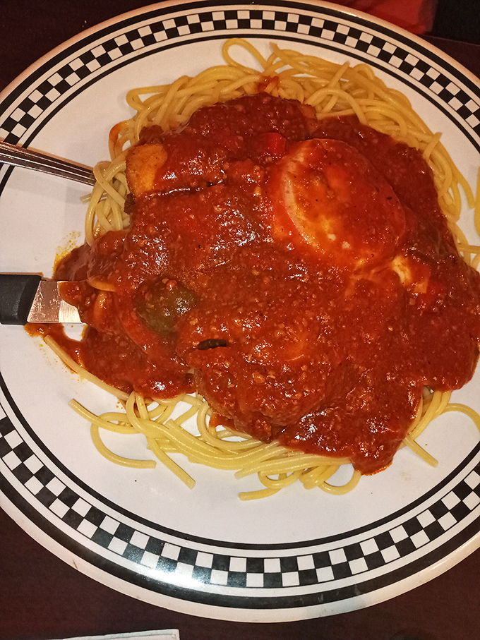 The star attraction! Chicken Parmesan sprawled across a bed of spaghetti like it owns the place&mdash;which it absolutely does. That sauce deserves a standing ovation.
