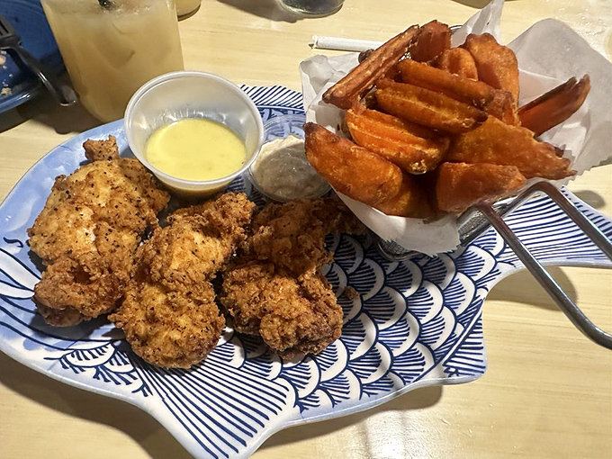 These aren't just chicken tenders&mdash;they're crispy, golden tickets to flavor town, with sweet potato fries that make regular potatoes question their life choices.