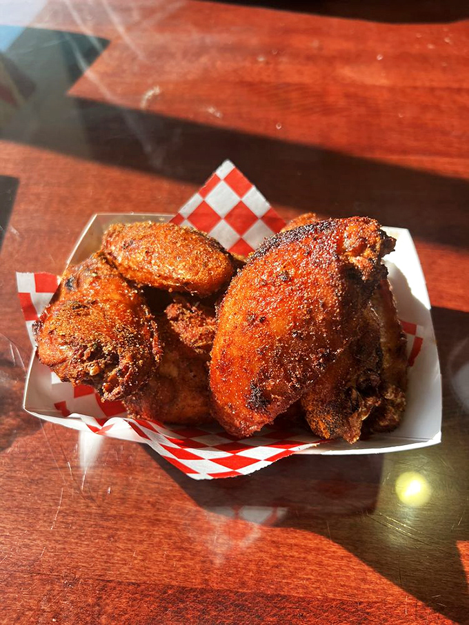 Dry-rubbed wings with a color that screams "I've been loved by smoke." These aren't afterthoughts&mdash;they're barbecue artistry in bite-sized form.