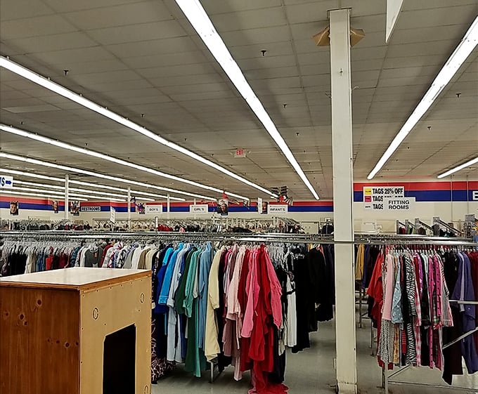 The clothing section stretches toward infinity, a textile rainbow where vintage treasures hide between everyday basics.