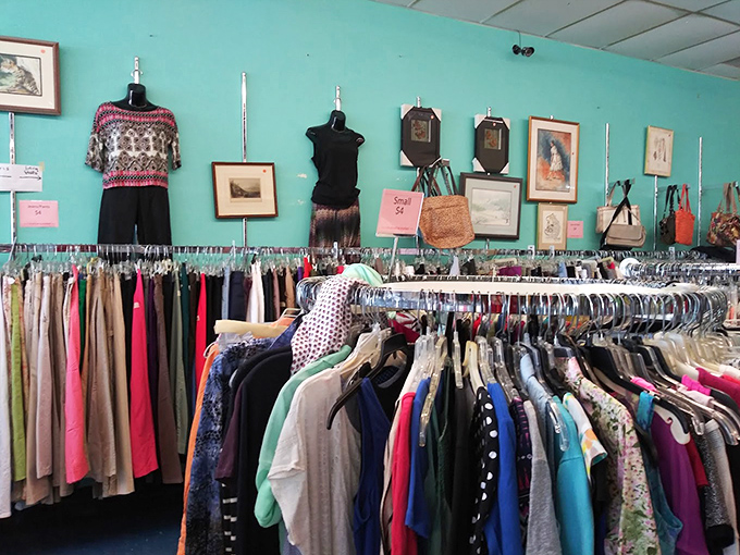 The clothing section's turquoise wall provides the perfect backdrop for fashion finds spanning decades &ndash; where vintage patterns meet contemporary classics.