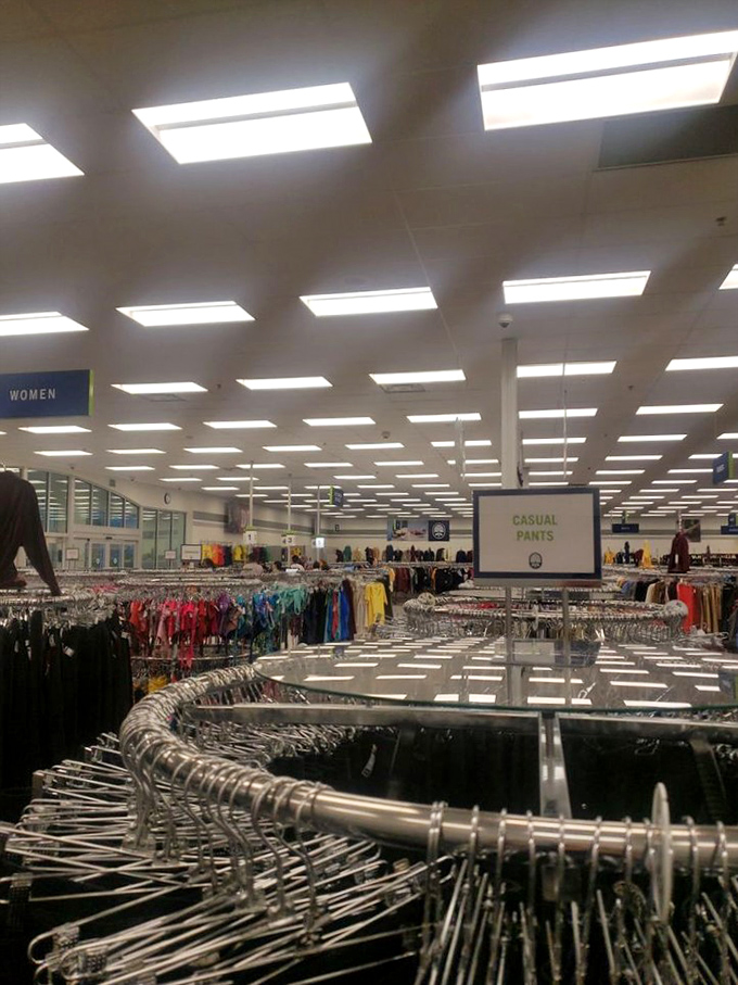 The women's clothing section stretches toward the horizon like a sea of possibilities, color-coded for the serious bargain hunter's convenience.