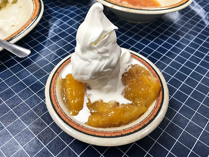 Peach cobbler topped with a cloud of whipped cream. The kind of dessert that makes you consider skipping the main course next time.