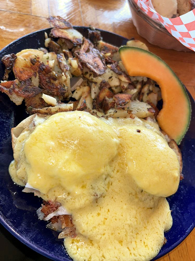 The Benedict that launched a thousand road trips: poached eggs nestled on hash, draped in Hollandaise, with perfectly crispy potatoes standing guard.