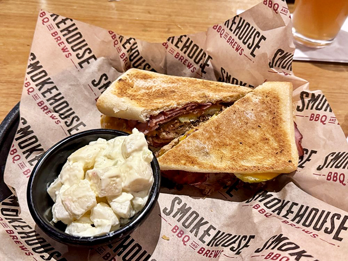 This isn't just a sandwich; it's architecture &ndash; layers of smoky meat and melty cheese between perfectly toasted bread, with potato salad standing guard.