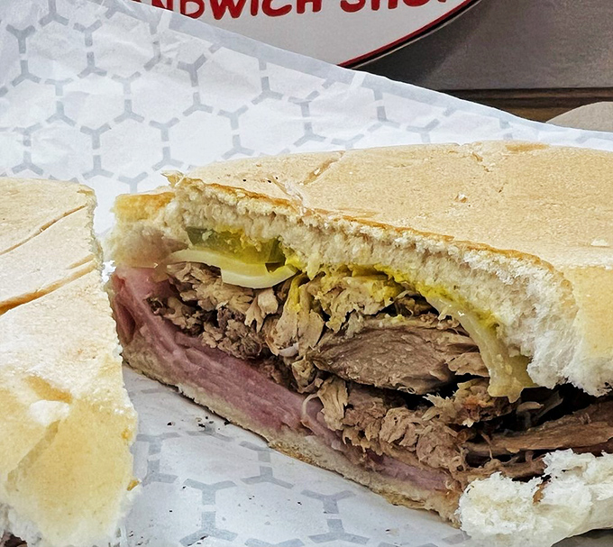 The Cuban sandwich cross-section reveals the architectural perfection that has locals lining up before sunrise.