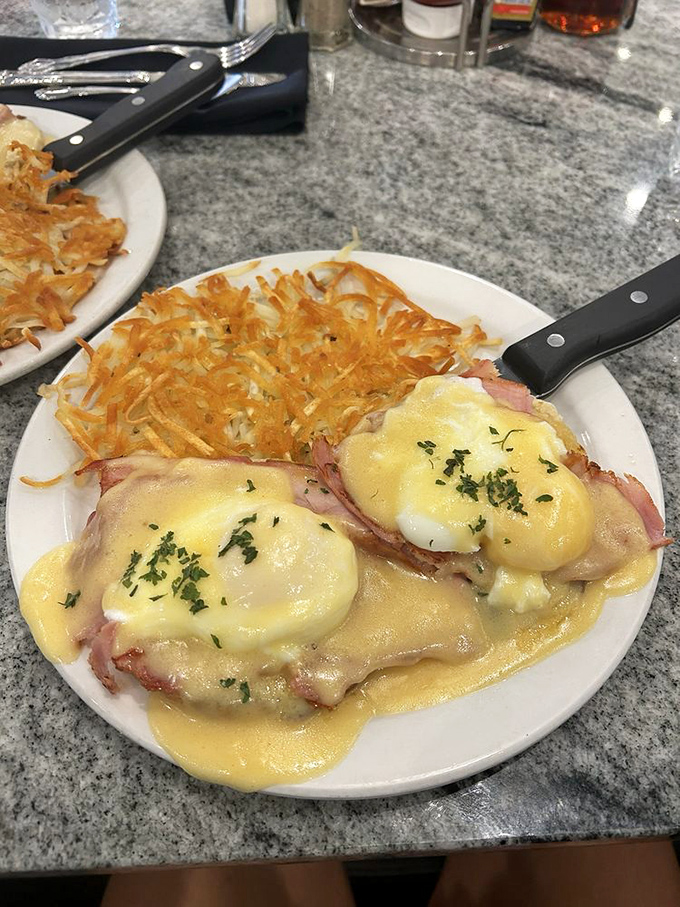 Eggs Benedict elevated to art form, with hollandaise that flows like liquid sunshine over perfection.