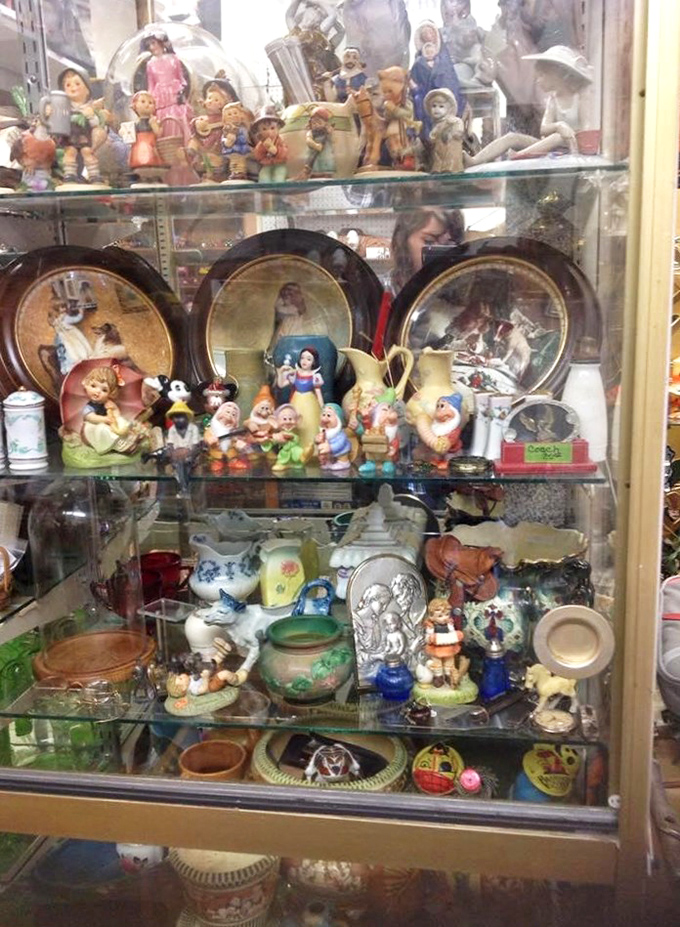 Snow White and her seven dwarfs hold court in this glass cabinet, surrounded by figurines that once graced Grandma's curio shelf.