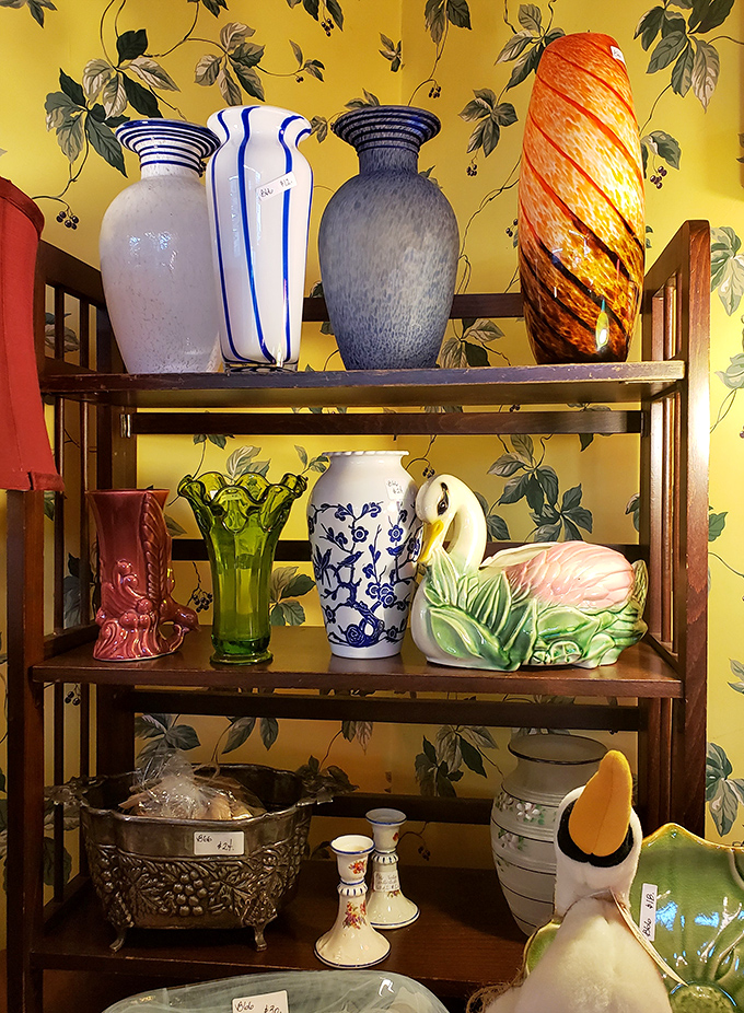 A rainbow of vintage vases stands at attention against cheerful yellow wallpaper &ndash; each one ready to showcase your farmers' market blooms.