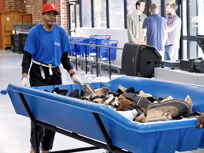 A staff member wheels out fresh inventory, the thrift equivalent of a five-star chef presenting the day's special. Anticipation builds among the waiting crowd.