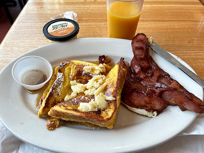 French toast that makes you understand why people line up in the rain. Paired with bacon cooked to that magical point between chewy and crisp.