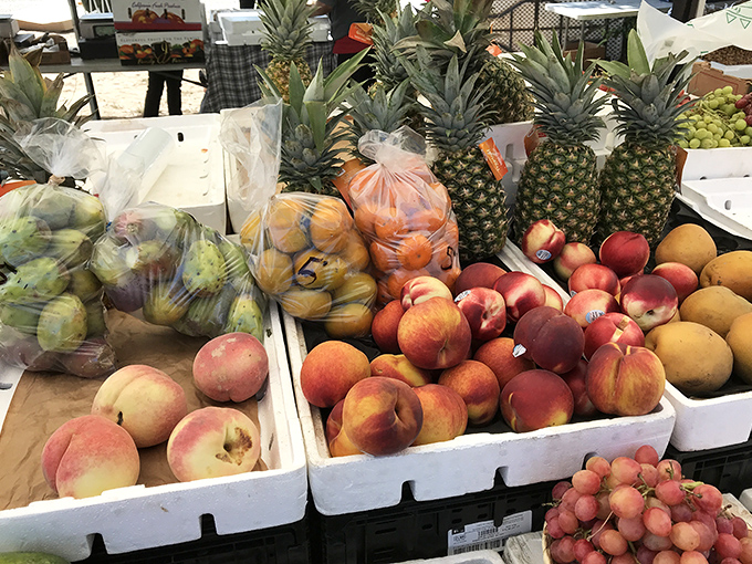 Nature's candy display! These fresh peaches, pineapples and produce make grocery store fruit look like distant, waxed cousins.