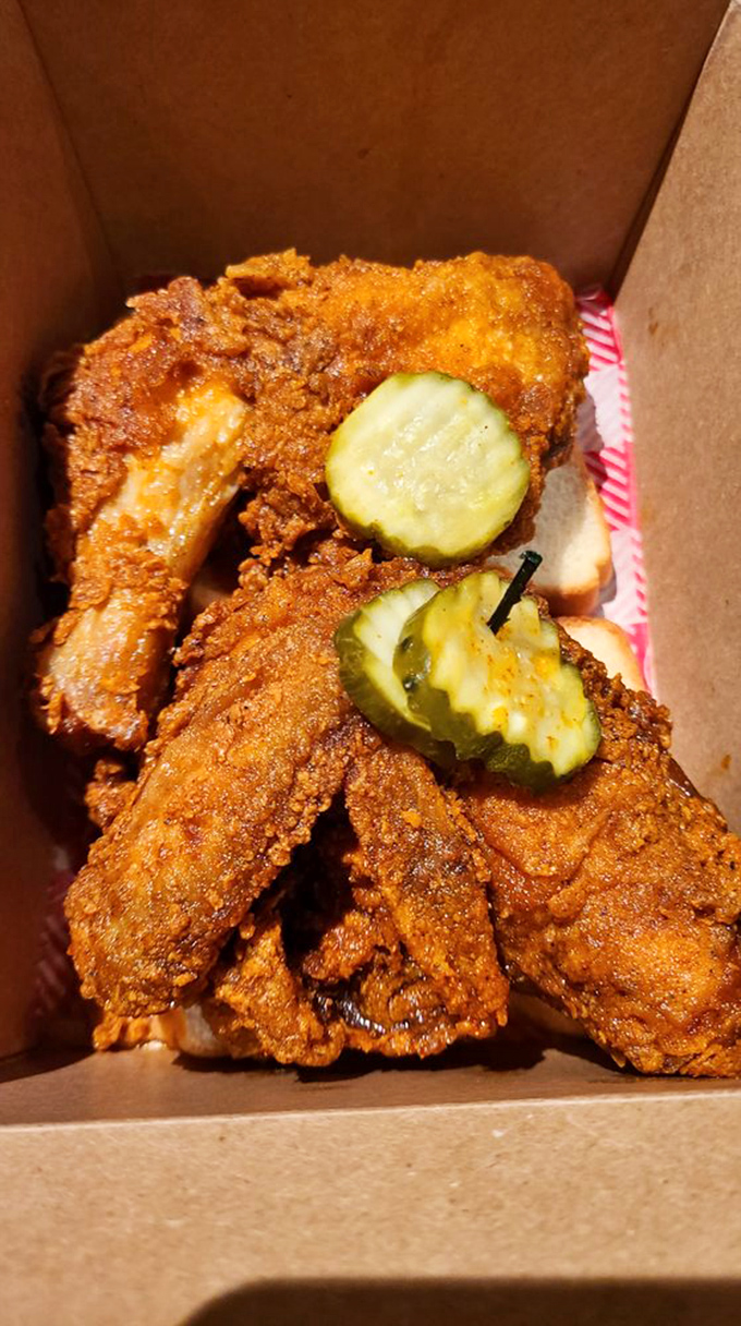 Golden-brown perfection with pickle coins standing guard. This isn't just fried chicken&mdash;it's Nashville's edible ambassador to the world.