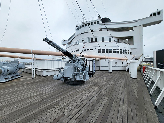The ship's massive deck artillery stands as a stark reminder of the Queen Mary's wartime service, when luxury gave way to duty during World War II.