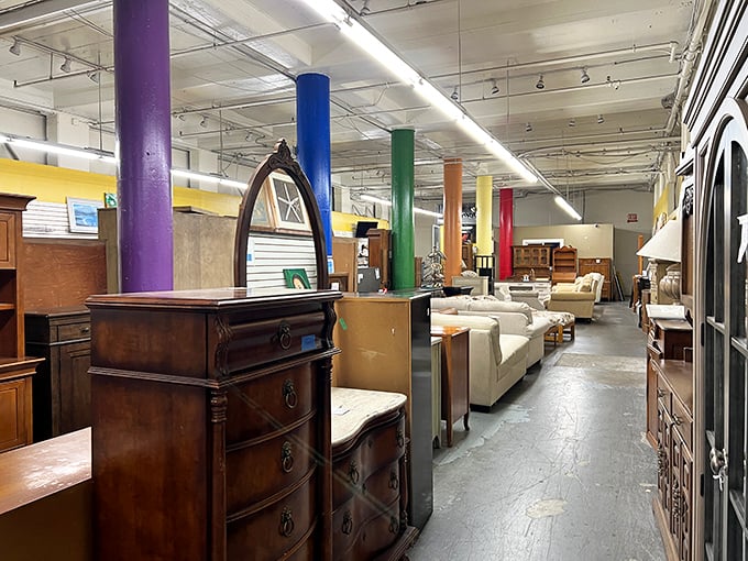 Furniture that spans decades sits in harmonious chaos. Those colorful support columns could tell tales of thousands of shoppers finding their perfect piece.