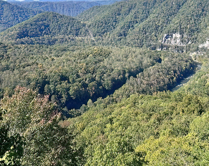 Nature's masterpiece on full display: the lush green mountain at Breaks Interstate Park creates a perfect triangle, with the Russell Fork River carving its path below.