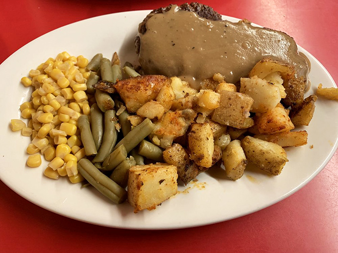 The home fries aren't just a side dish, they're the main event &ndash; golden-brown cubes sharing the spotlight with perfectly seasoned vegetables and gravy-smothered meat.