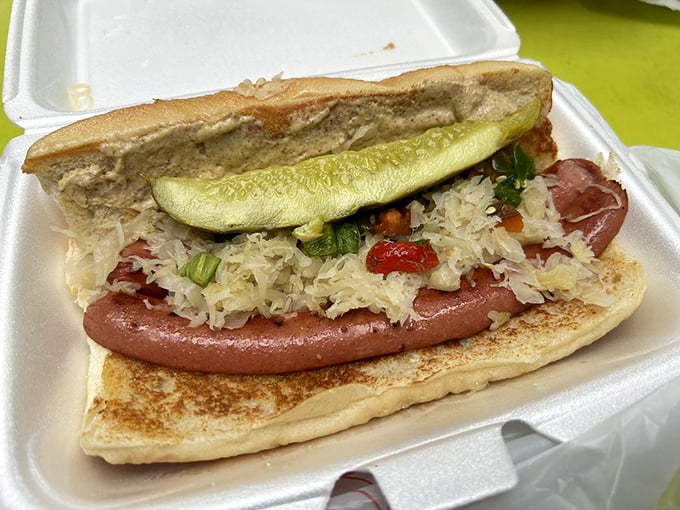 Not just any hot dog – a carefully crafted sausage sanctuary with kraut and pickle that transforms lunch into a miniature vacation.
