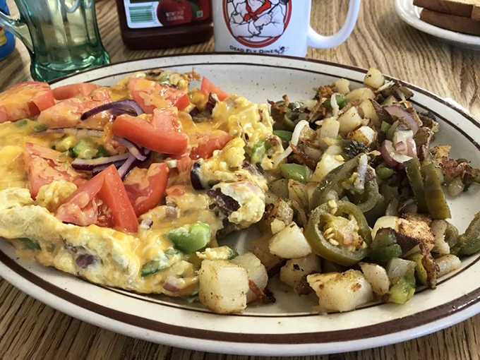 This isn't just an omelet&mdash;it's a color wheel of morning delights, with those home fries looking like they've achieved the perfect crisp-to-tender ratio.