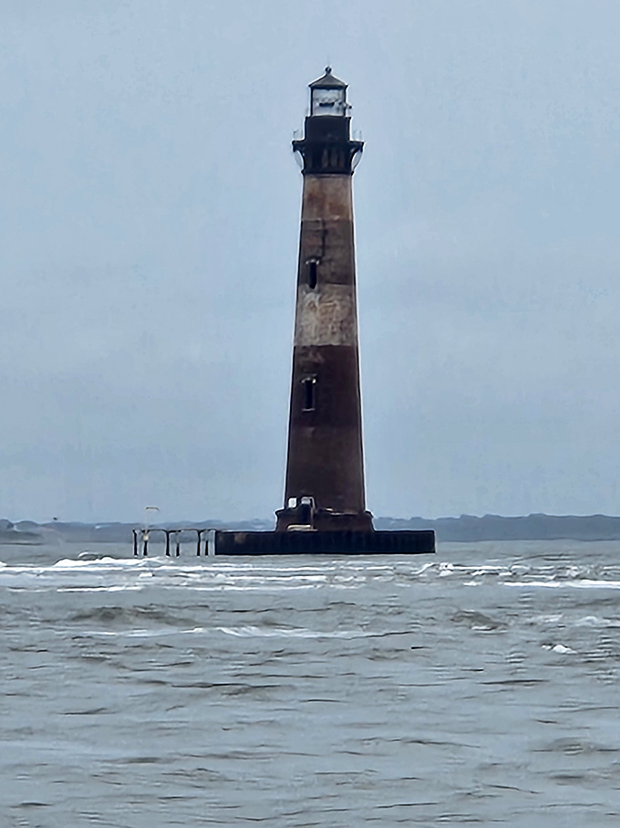 The Morris Island Lighthouse stands defiant against time and tide, a stubborn beauty refusing to surrender to the Atlantic.