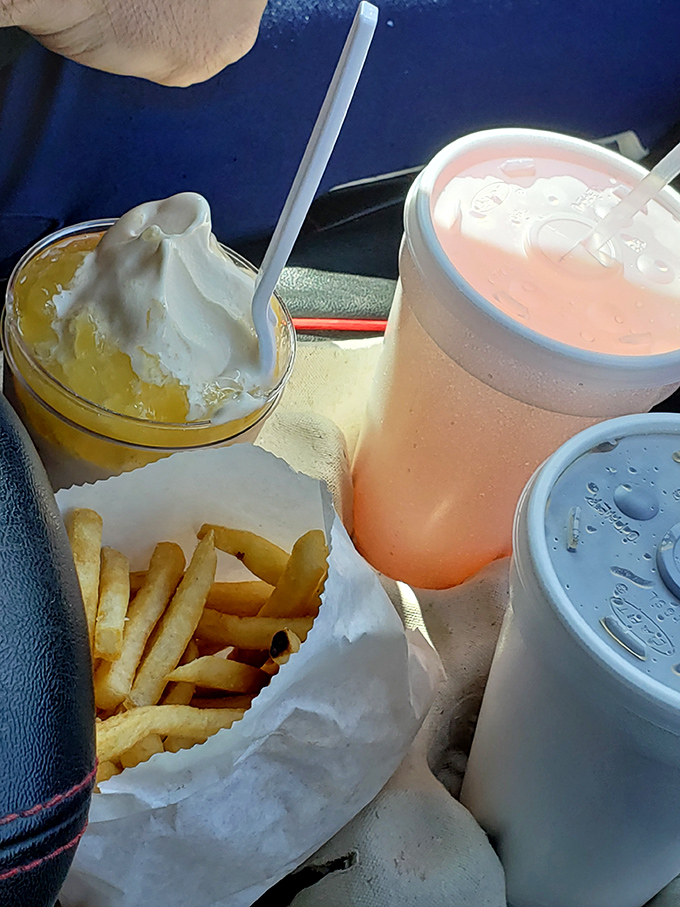 The holy trinity of drive-in dining: golden fries, creamy shakes, and something pink that promises refreshment on a hot Lodi afternoon.