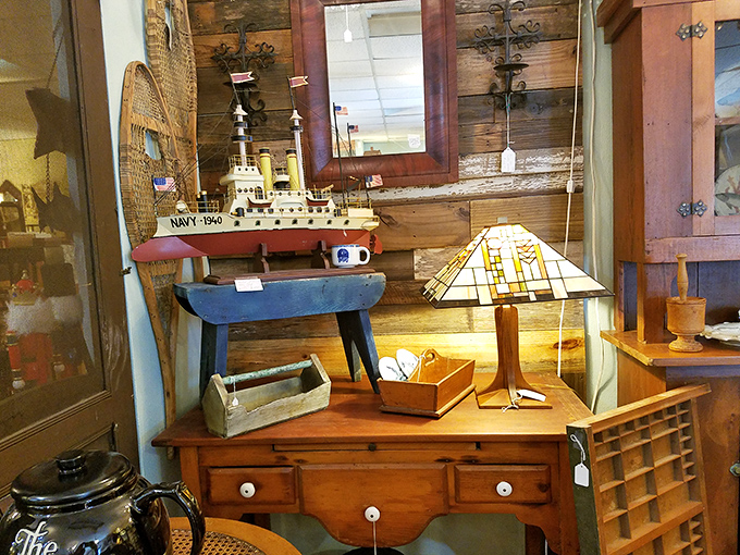 Maritime nostalgia docks alongside a Tiffany-style lamp. This vintage Navy ship model would make any landlubber's desk feel seaworthy.