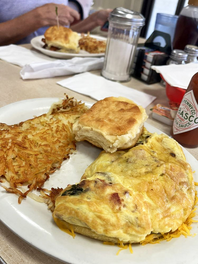 An omelet that doesn't need fancy cheese names to impress, paired with hash browns so perfectly crispy they deserve their own fan club.