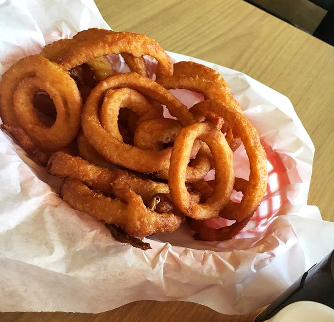 Onion rings that achieve the perfect crunch-to-softness ratio – the burger sidekick that occasionally steals the spotlight from its more famous partner.