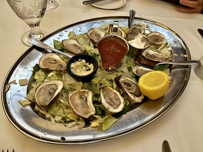 Fresh oysters arranged like jewels on a silver platter. The ocean's perfect appetizer, served with the same elegant simplicity as they were a century ago.
