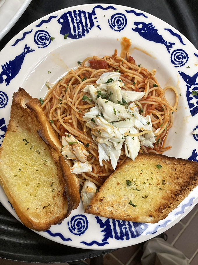 Spaghetti with fresh crab meat and garlic bread&mdash;proof that sometimes the simplest combinations create the most profound happiness.