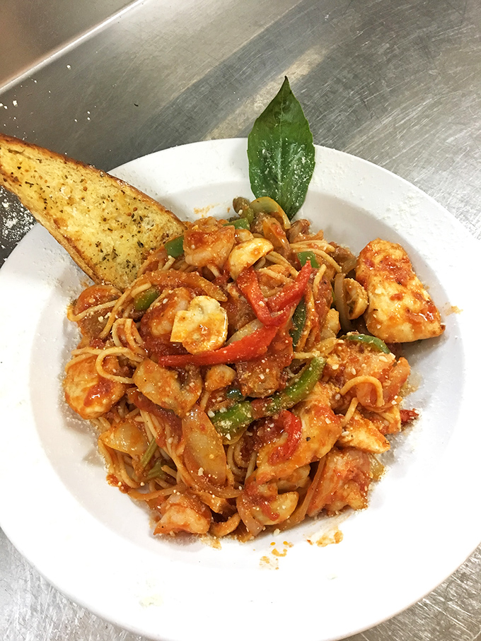 Pasta that would make your Italian grandmother nod in approval&mdash;vibrant, saucy, and adorned with a garlic bread sidekick that deserves its own fan club.