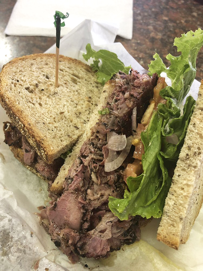 This pastrami masterpiece has more layers than a Shakespearean tragedy. The meat-to-bread ratio achieves that elusive deli harmony we all seek in life.