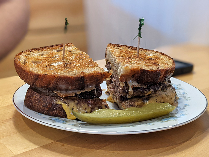 The patty melt that launched a thousand sighs, where melty cheese meets caramelized onions in perfect harmony.