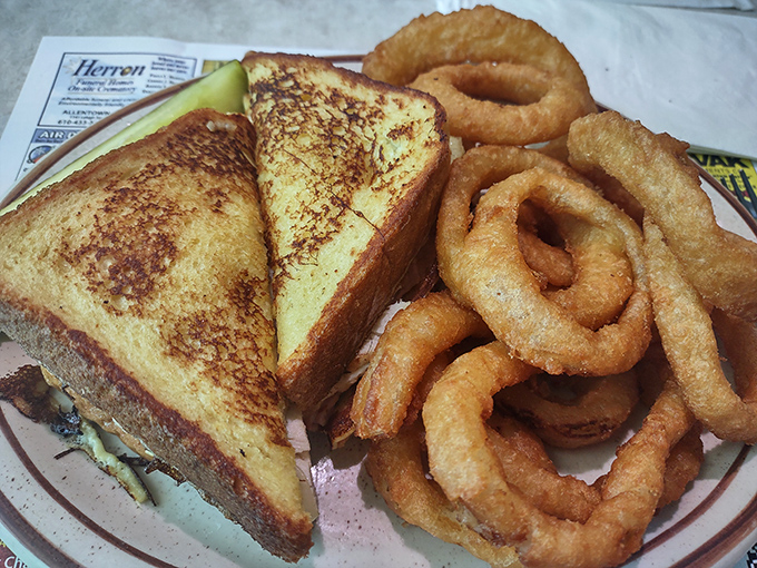 The patty melt&mdash;diner royalty on a plate. Golden-grilled bread embracing melted cheese and a juicy patty, with onion rings that deserve their own fan club.