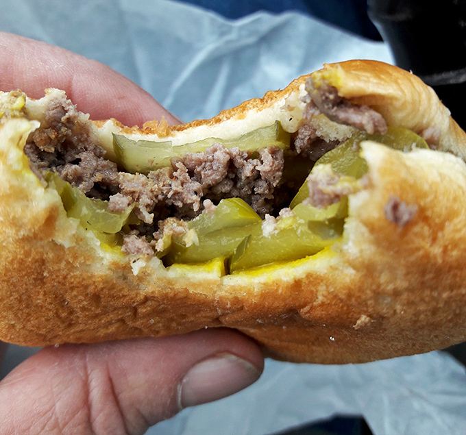 A bite reveals the secret – those pickle chips aren't just garnish, they're the acid jazz in this meaty symphony.