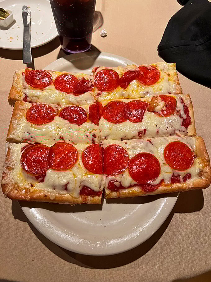 Old Forge-style pizza isn't just rectangular&mdash;it's revolutionary. Those pepperoni coins aren't toppings; they're edible treasure on a cheese-laden map.