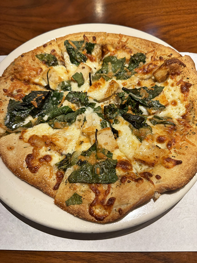 Pizza that achieves the holy trinity: crispy crust, melty cheese, and fresh toppings. The spinach adds just enough virtue to justify ordering a second.