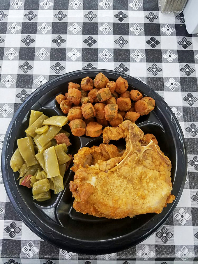 Southern comfort on a plate&mdash;crispy pork chop, perfectly fried okra, and sides that make you question why you'd eat anywhere else.