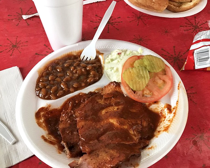 The holy trinity of Southern comfort: smoky pork, creamy slaw, and beans that have clearly been simmering since breakfast.