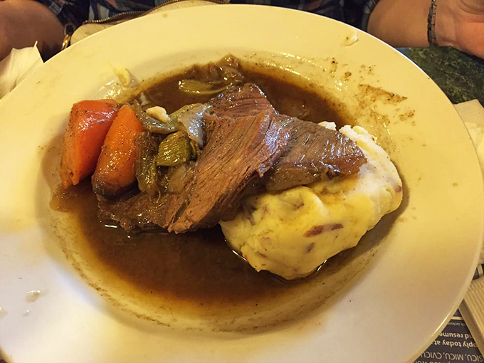 The pot roast arrives like a Sunday dinner at grandma's house—if grandma was secretly a five-star chef with a flair for gravy artistry.