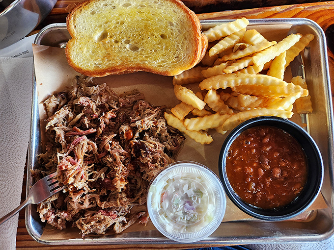 Pulled pork that's had a proper introduction to smoke before meeting your taste buds. The beans aren't just a side&mdash;they're a supporting character.
