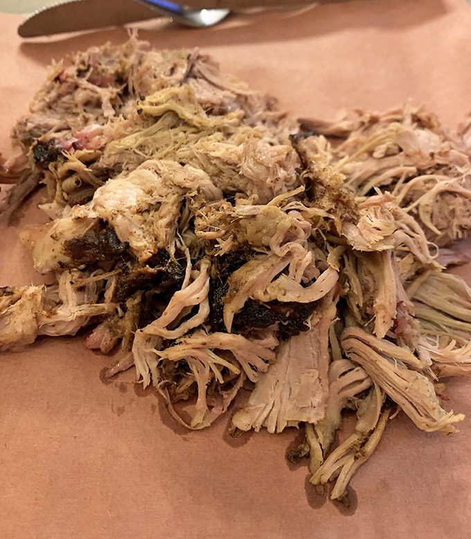 Pulled pork that looks like it's having a very good hair day. Each strand a testament to low-and-slow cooking philosophy.