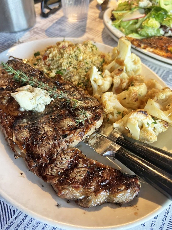 Who says seafood restaurants can't nail a steak? This ribeye with herb butter is making a compelling argument for turf in a sea of surf.