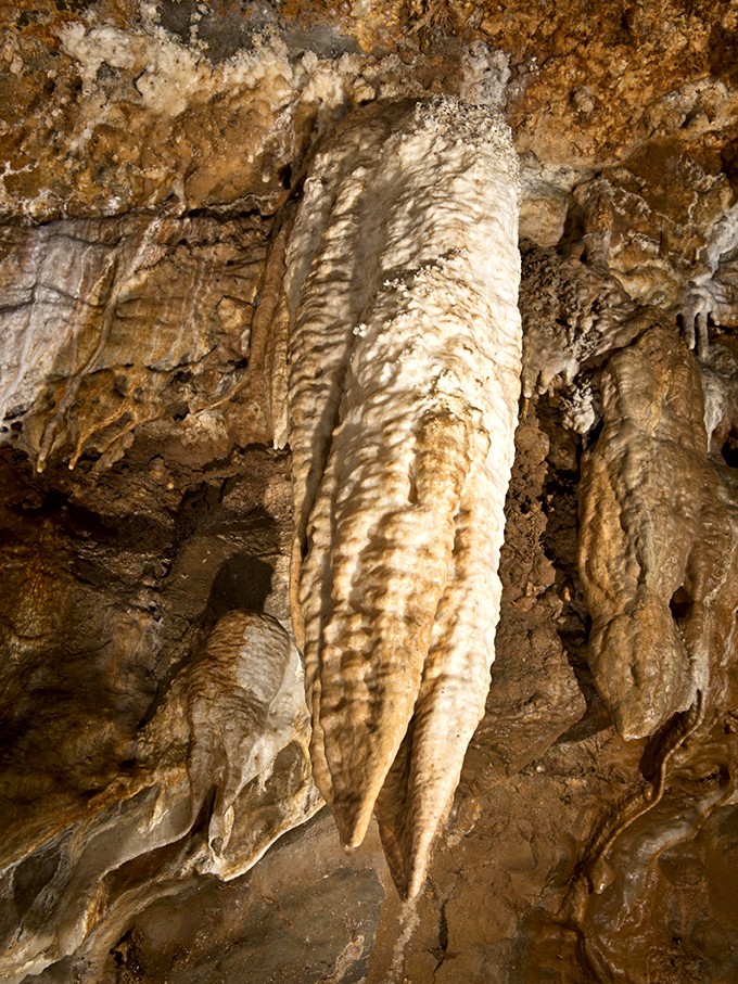 The cavern walls bear witness to ancient geological processes, their textures and patterns more intricate than any human-made design.