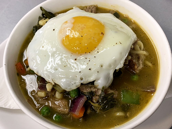 A steaming bowl of broth cradling vegetables, meat, and a sunny-side-up egg. Like a warm hug on a cold day, this soup doesn't just satisfy&mdash;it restores.