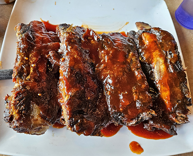 Ribs so glossy they could be in a barbecue magazine centerfold. That sauce-to-meat ratio isn't an accident&mdash;it's barbecue science perfected over decades.