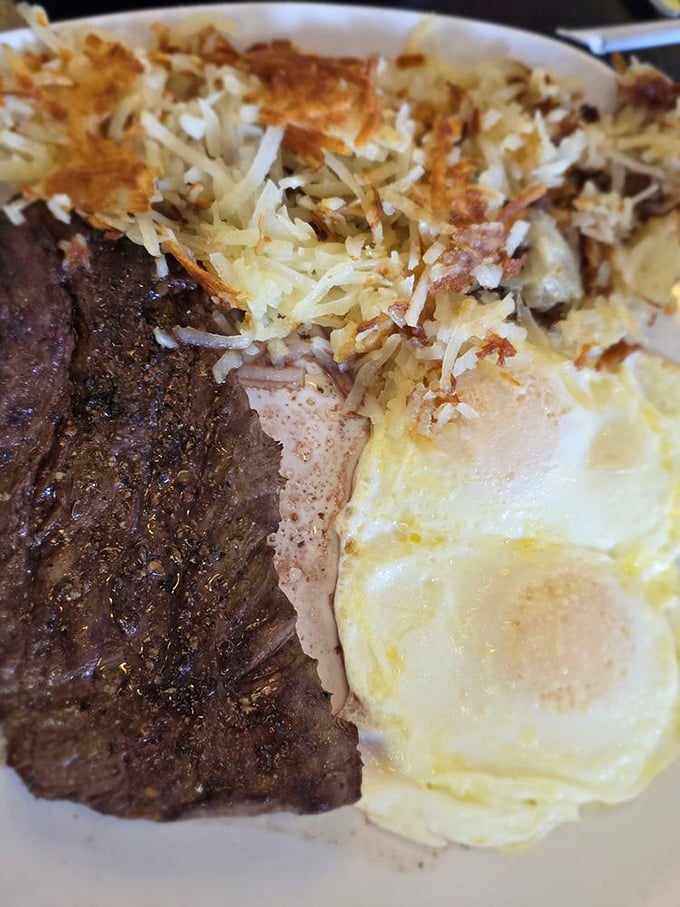 The holy trinity of breakfast: perfectly seared steak, sunny-side eggs, and hash browns with the ideal crisp-to-tender ratio. Morning indulgence at its finest.