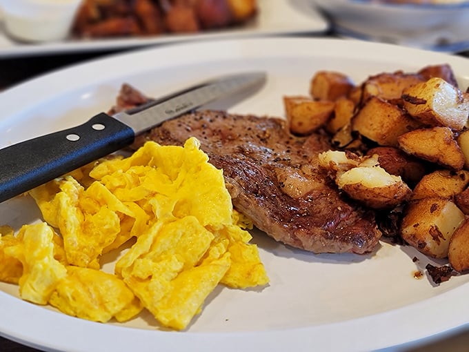 The holy trinity of breakfast: perfectly seasoned steak, fluffy scrambled eggs, and potatoes that have achieved their highest purpose.